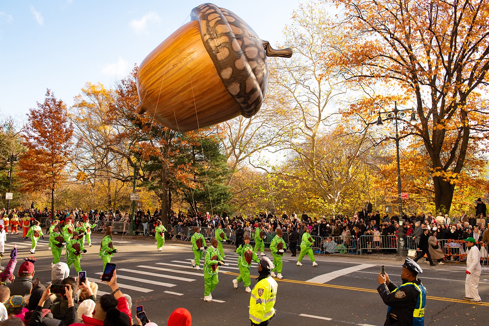 A larger than life parade in New York featuring individuals dressed in ...