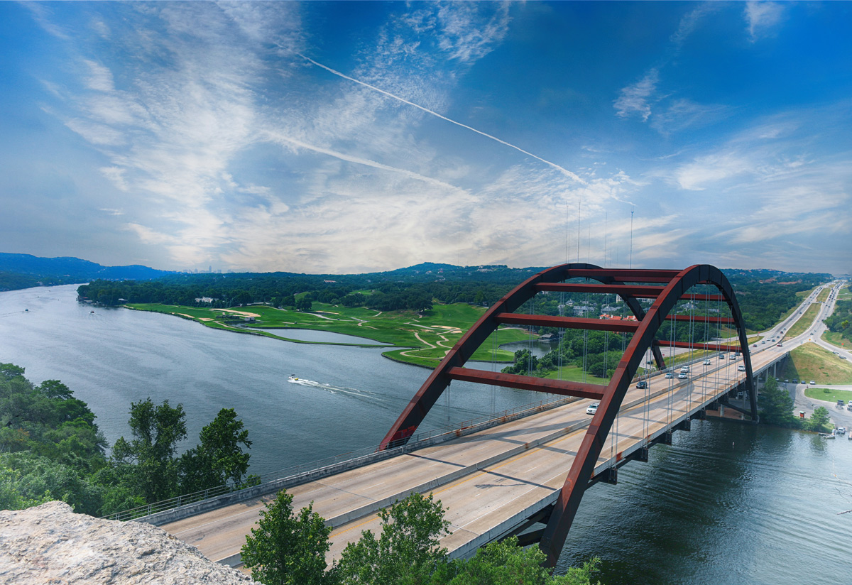 A bridge over Lake Austin, Texas, spanning a serene river with a clear ...