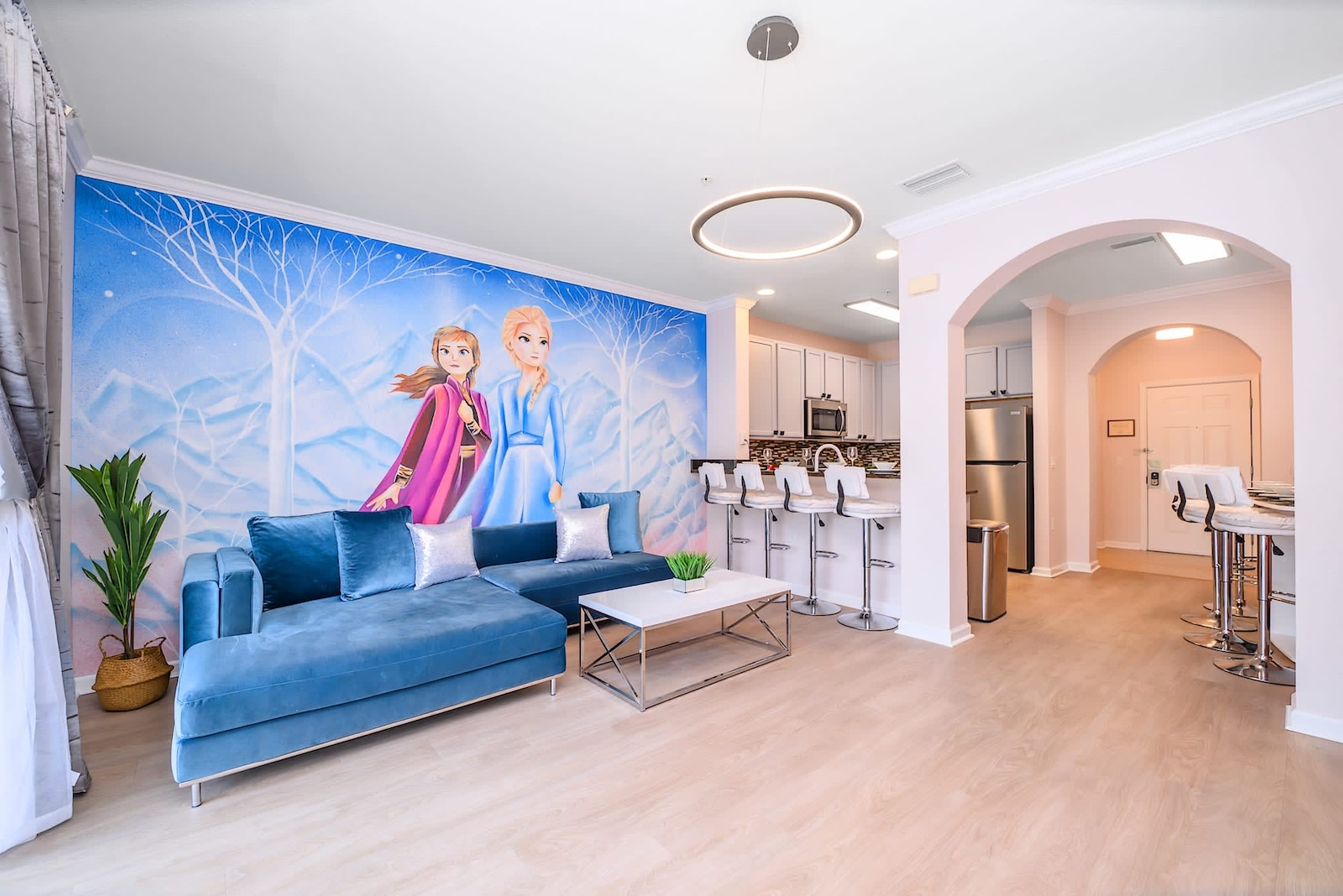 A luxurious living room featuring a Frozen-themed mural, perfect for ...