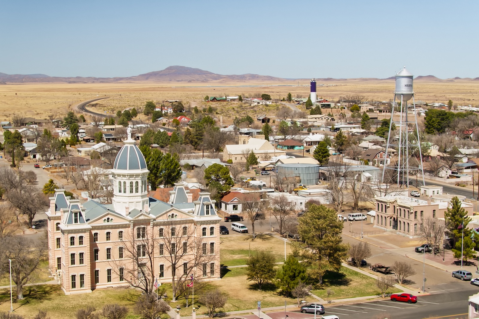 A view of Marfa, Texas, featuring a prominent water tower alongside a ...