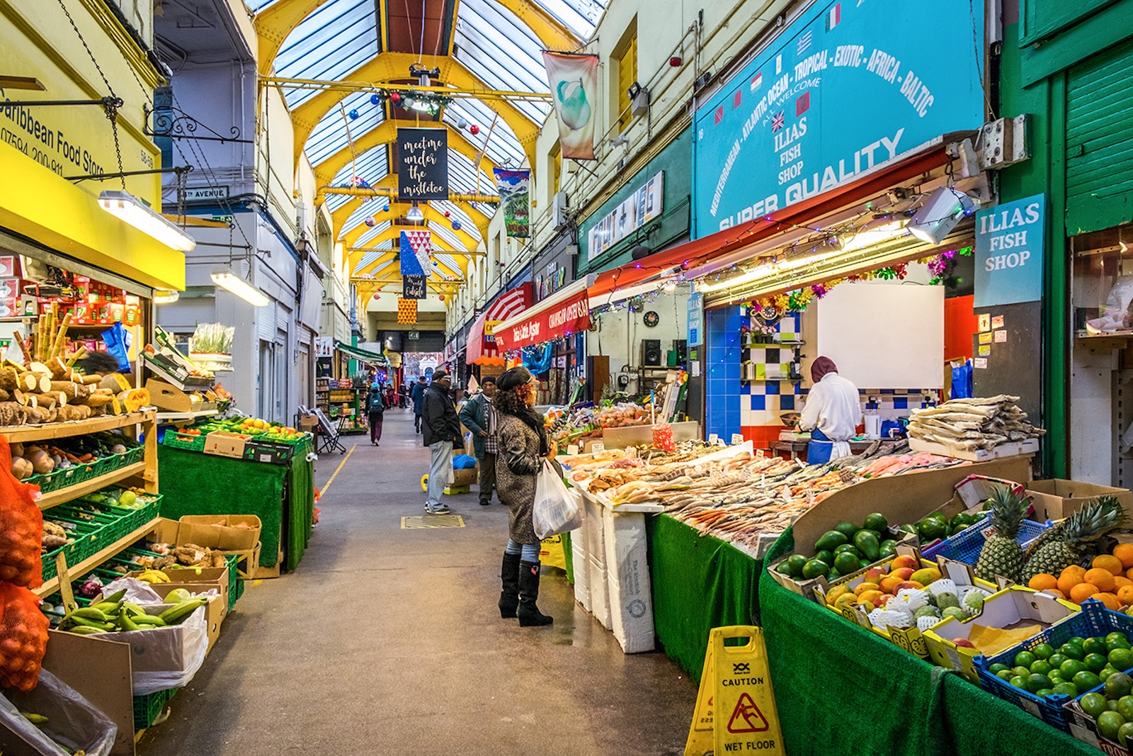 Brixton Market is bustling with shoppers exploring vibrant stalls ...
