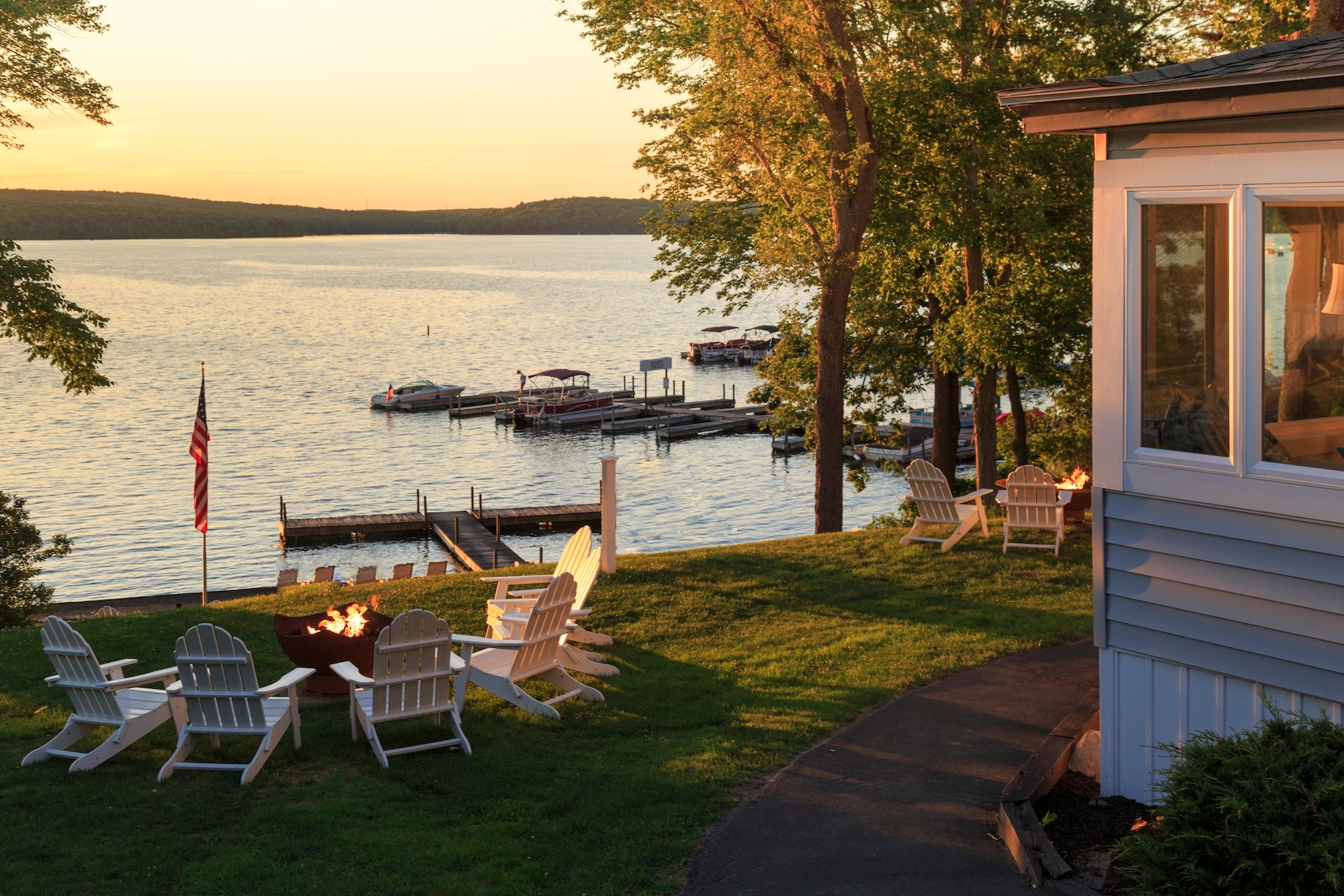 Tranquil Poconos lake featuring a picturesque house on its banks ...