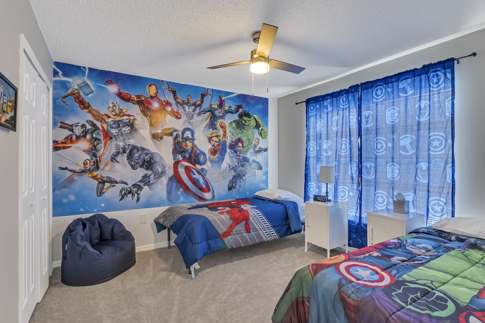 A Disney-themed bedroom featuring a vibrant wall mural of characters ...